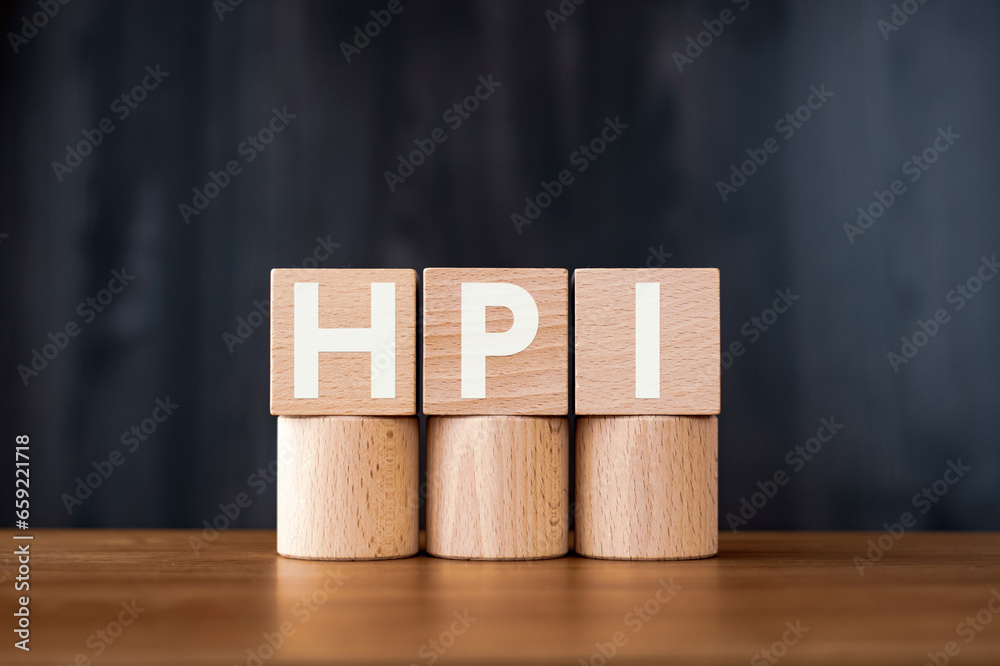 There is wood cube with the word HPI. It is an abbreviation for Human ...