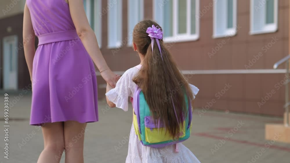 child smiles looks mother. happy family. small child with school ...