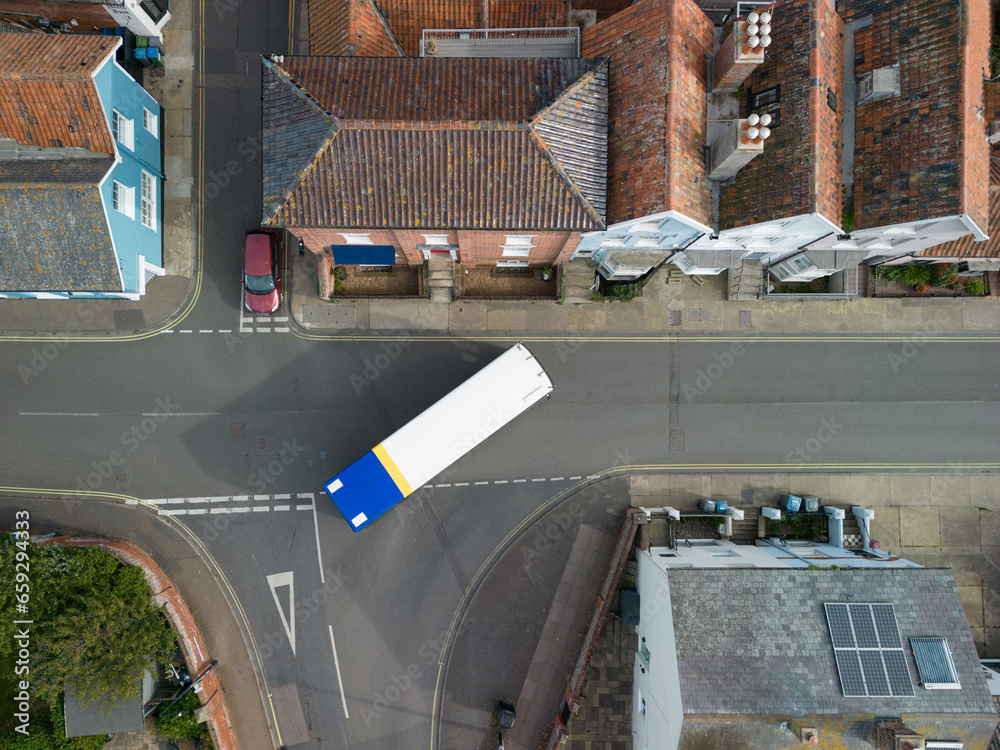 Drone view of a public bus seen making a sharp turn into the high ...