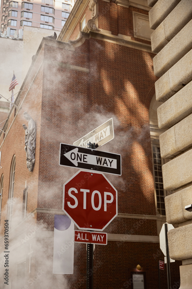 road signs near steam and vintage buildings on street of new york city ...