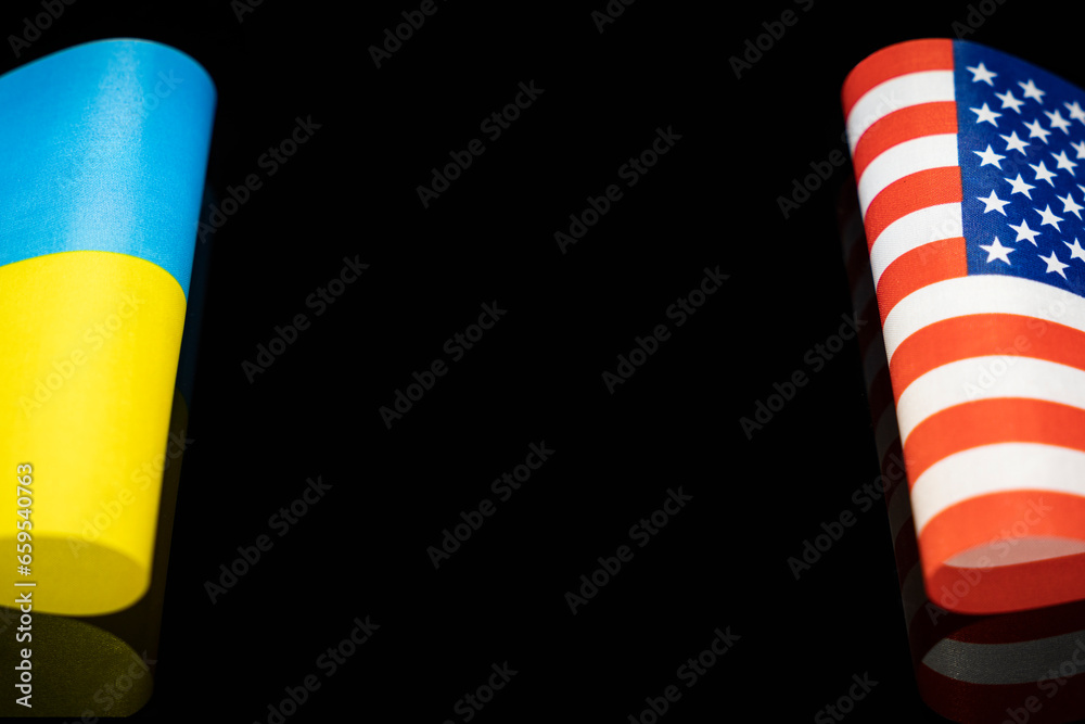 flags of the USA and ukraine on a black background. The concept of ...