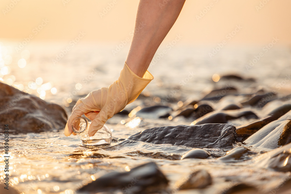 Hand wearing rubber glove intake test sample flask of water from river ...