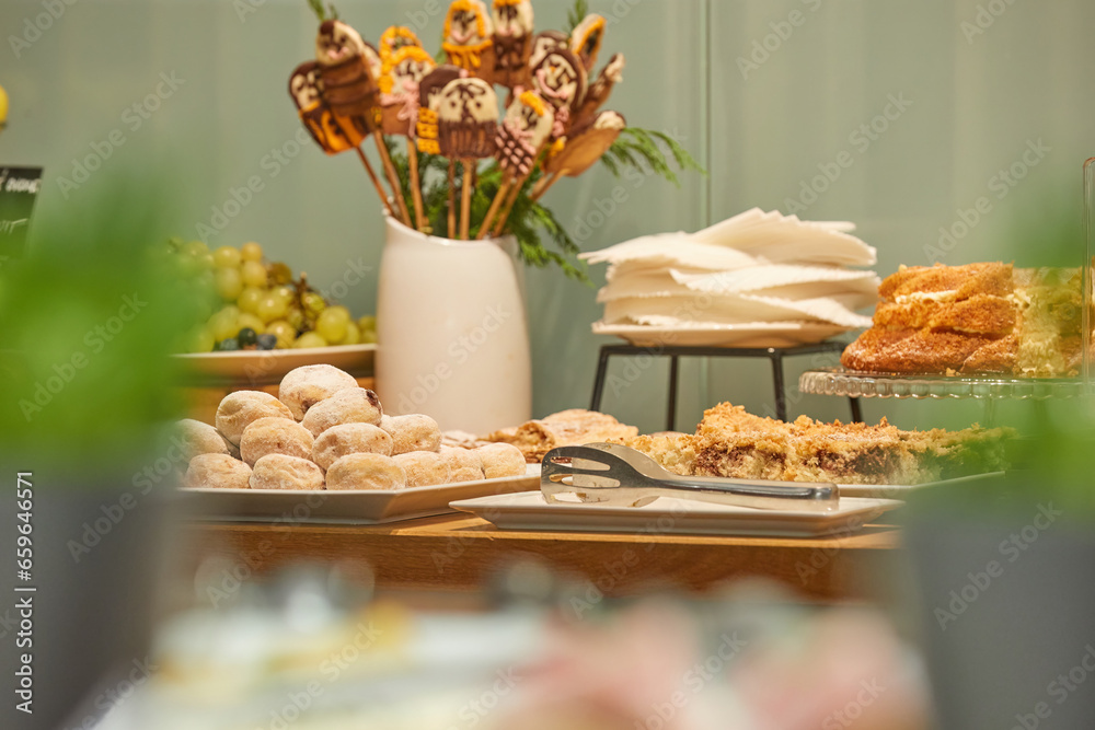 Breakfast in hotel, lighted table with various dishes, fruit and sweet ...