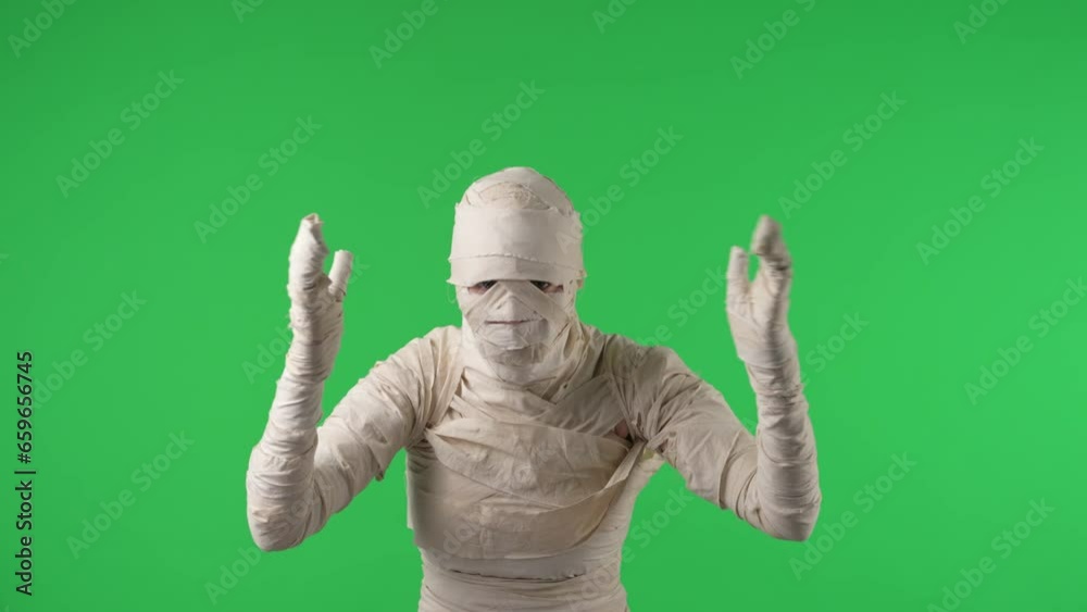 Green screen isolated chroma key video capturing a mummy shaking its ...