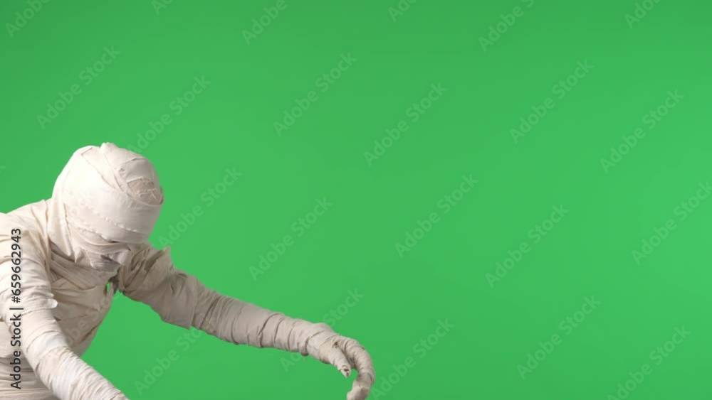 Green screen isolated chroma key video capturing a mummy staggering ...