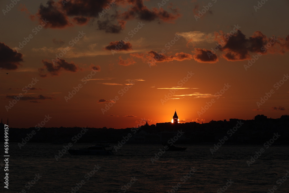 Fiery sunset over the Bosphorus with the famous Maiden's Tower (Kiz ...