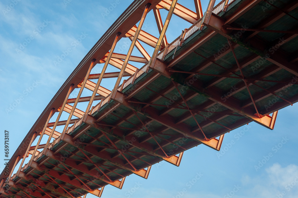 Detail of a red metal bridge against a lovely blue sky. Rainbow Bridge ...
