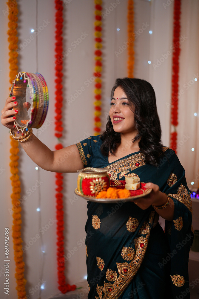 Newly-wed Indian woman celebrating Karwa Chauth festival in traditional ...