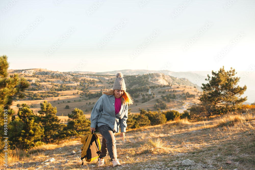 The plus size woman walks in the mountain. The gil admires beautiful ...