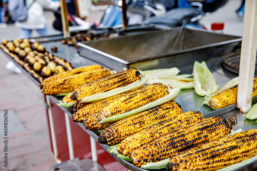 A street vendor roasts corn on a charcoal grill in Istanbul, Turkey ...