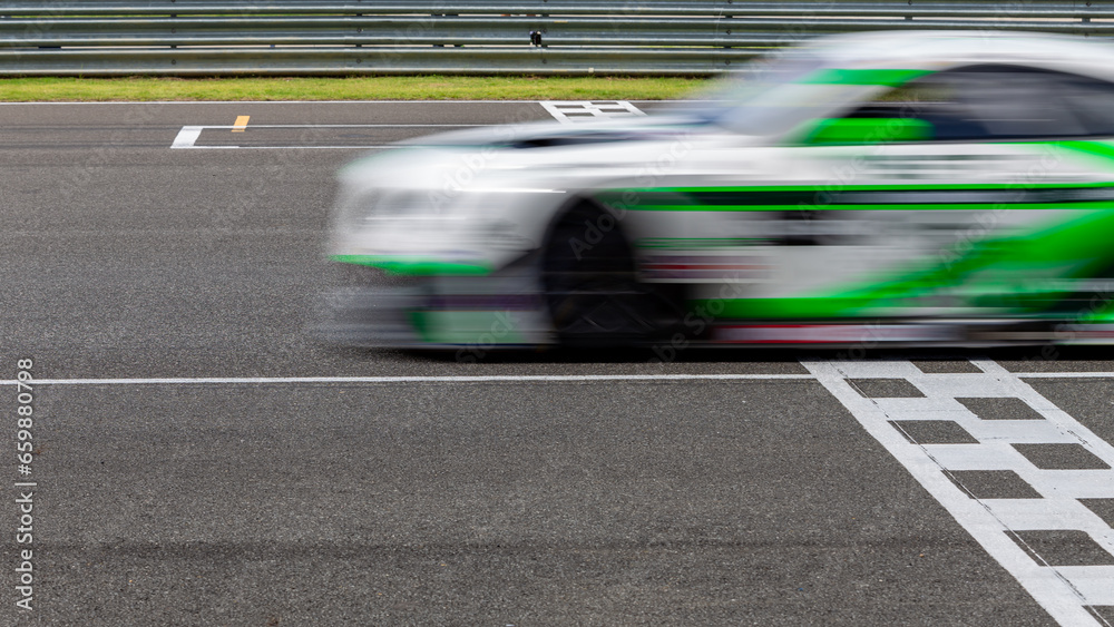 Race car blurred motion crossing the finish line on international ...