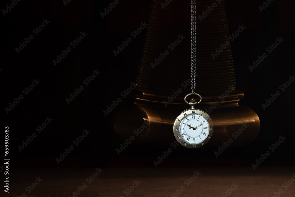 Hypnosis session. Vintage pocket watch with chain swinging over surface ...