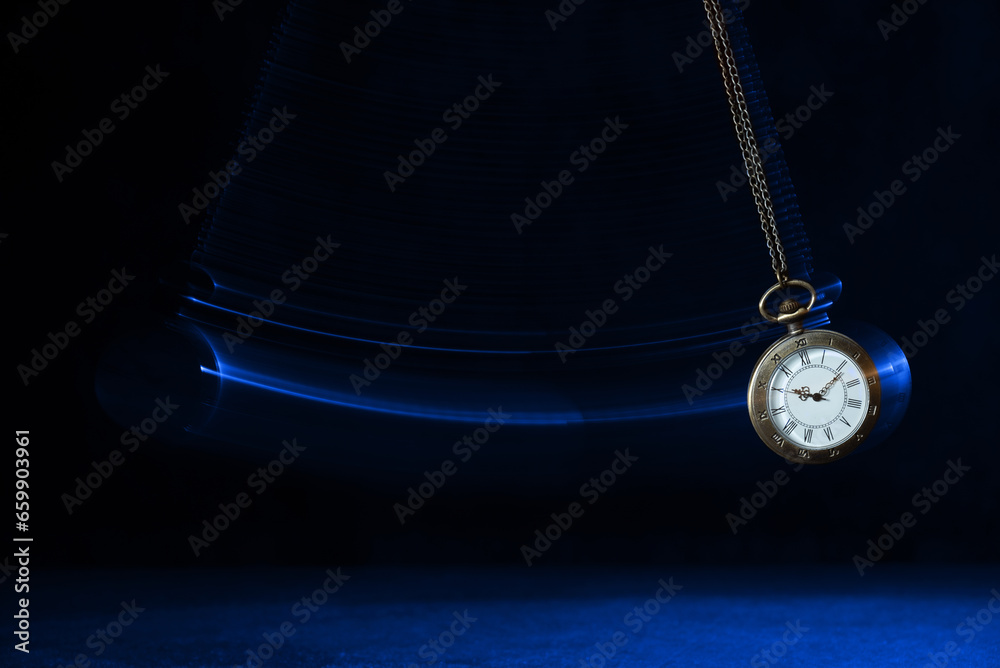 Hypnosis session. Vintage pocket watch with chain swinging over surface ...