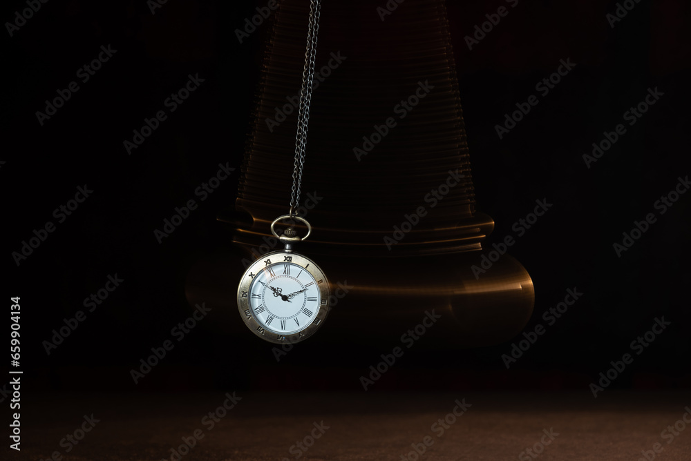 Hypnosis session. Vintage pocket watch with chain swinging over surface ...