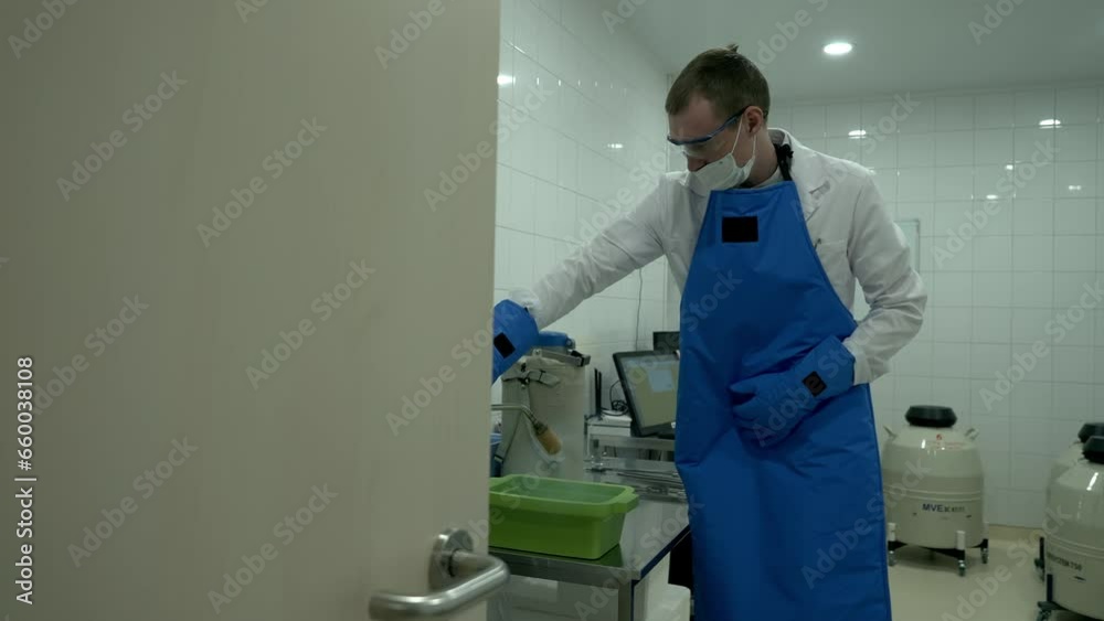 Specialist freezing the human embryo sample using cold liquid nitrogen ...