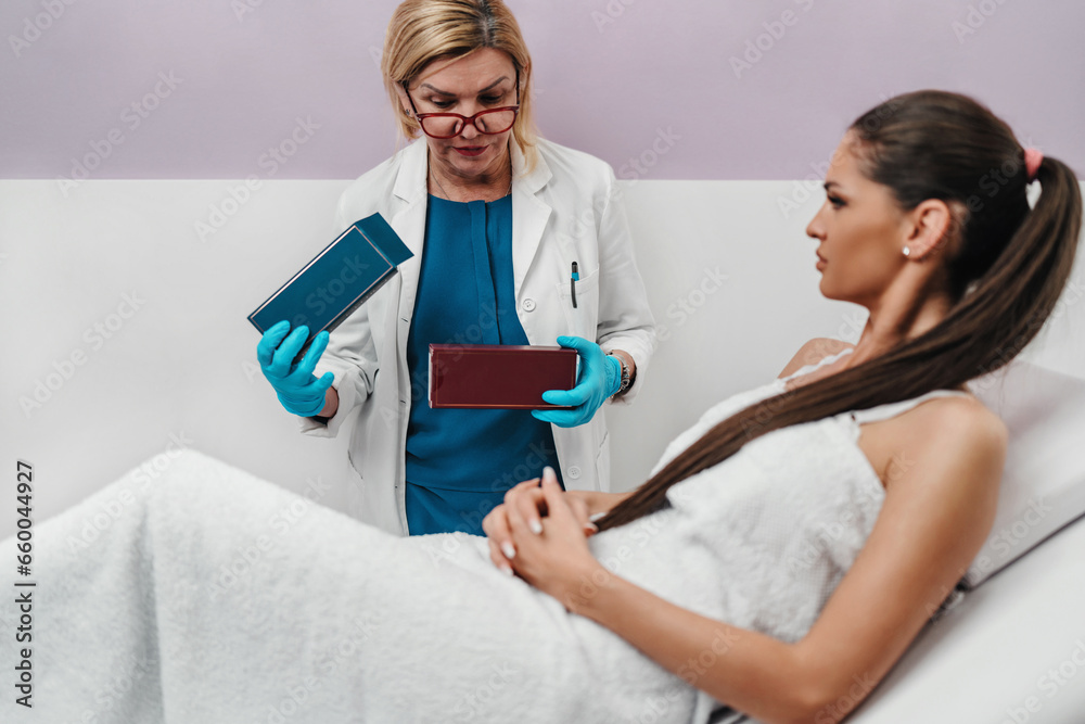 Beautiful and happy brunette woman at beauty medical clinic. She is ...