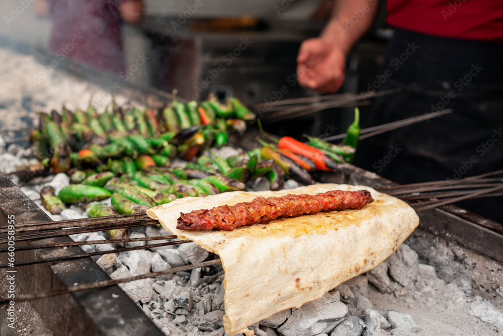 Turkish traditional kebab with pita bread and green peppers on a bbq in ...