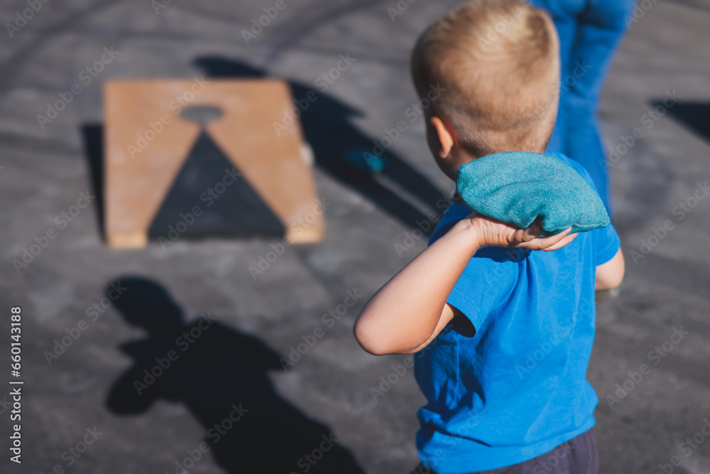 Cornhole game set, process of throwing bean bags, kids children tossing ...