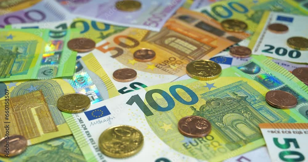 Real euro banknotes and metal coins of various colors, size and ...