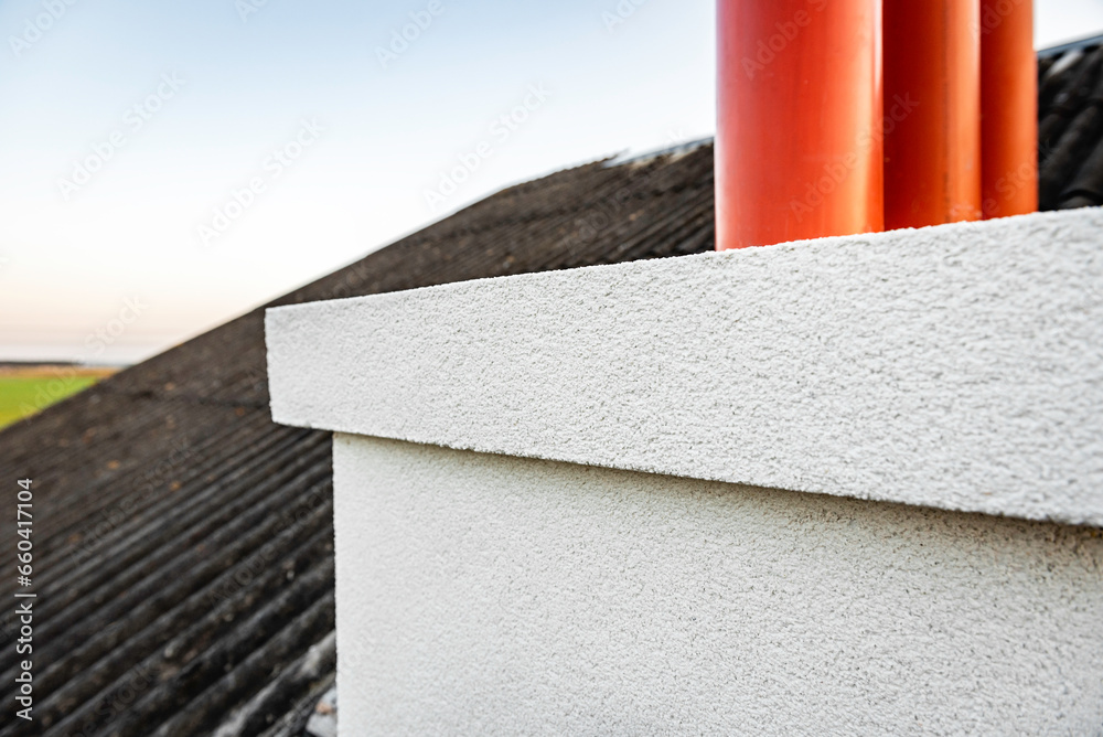 Applying white seamless concrete pebble-dash plaster on chimney. Stock ...
