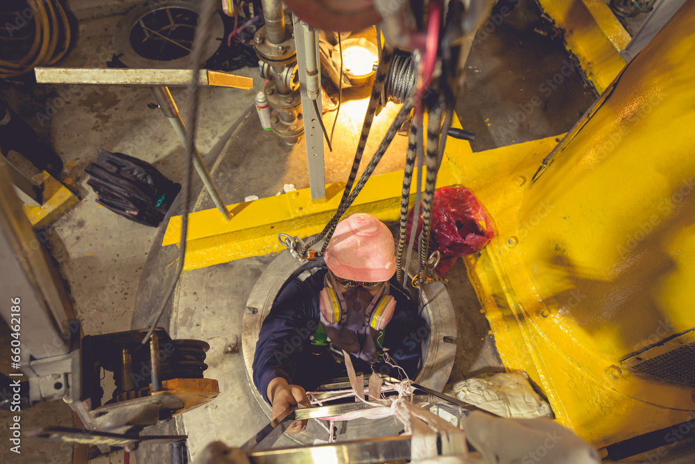 Top view male climb up the stairs into the tank stainless chemical area ...