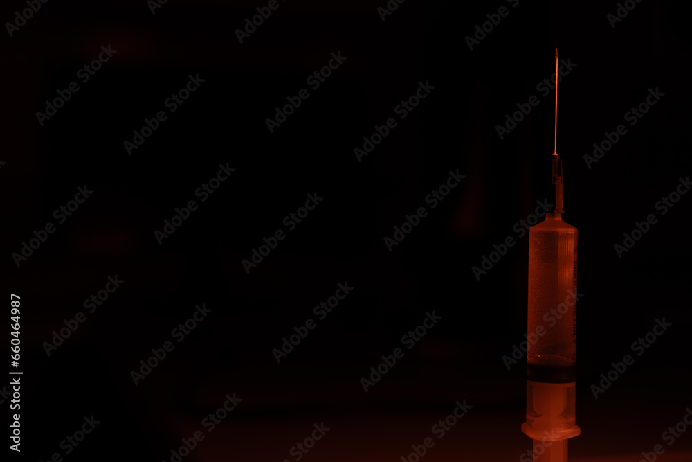 injection Photography in a red light with the left side of empty space ...