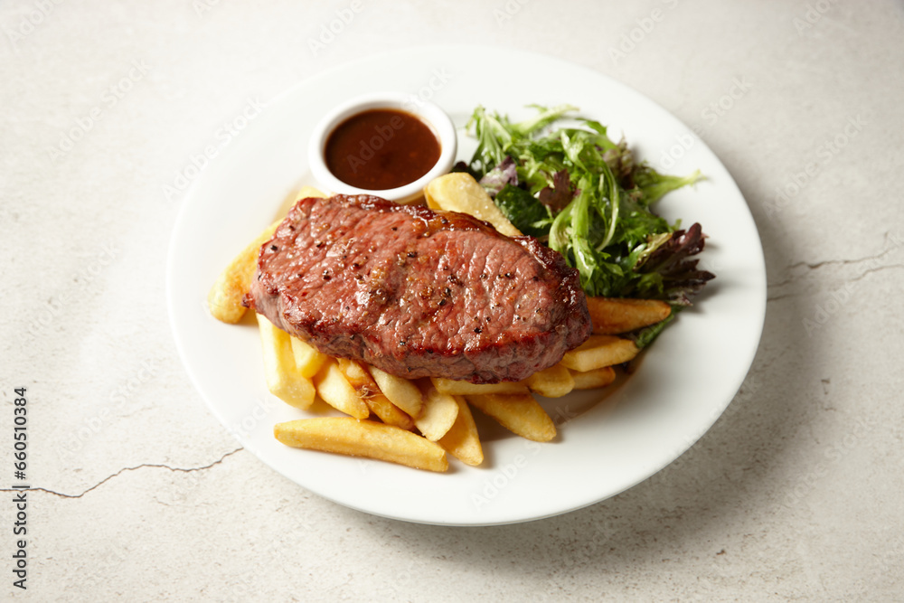 Black angus sirloin steak with fries and salad Stock Photo | Adobe Stock