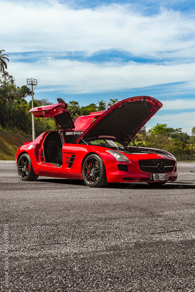 Front view of a red Mercedes Benz SLS AMG with its gullwing doors and ...