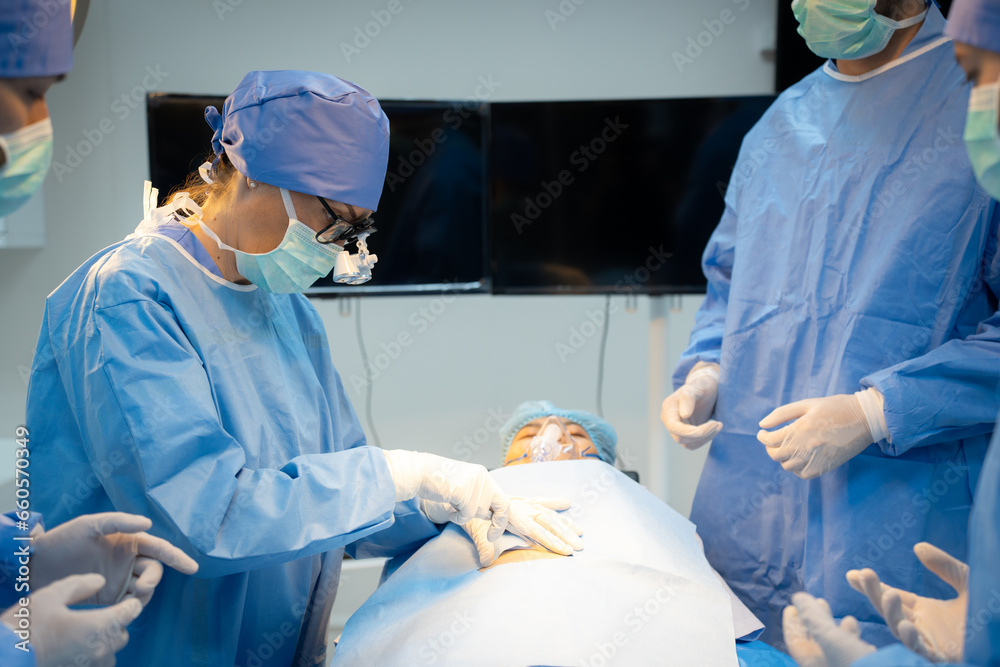 Selective focus, side view of a Caucasian female surgeon in blue ...