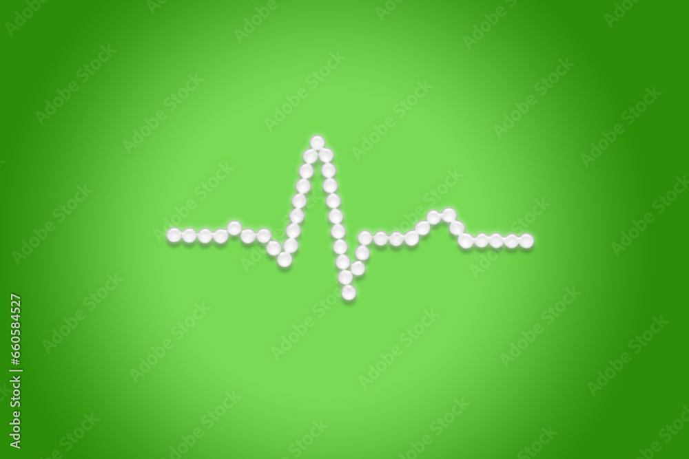 ECG wave form made of medical pills against a green background. PQRST ...