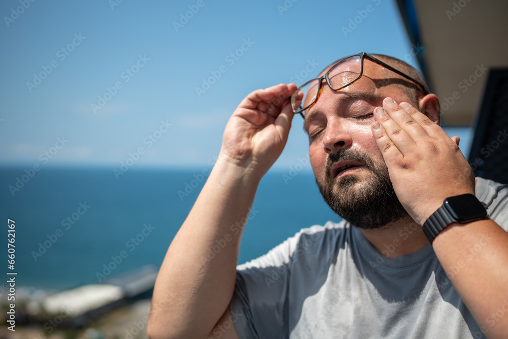 Bald man drenched in sweat wiped off excess moisture. Fat bearded guy ...