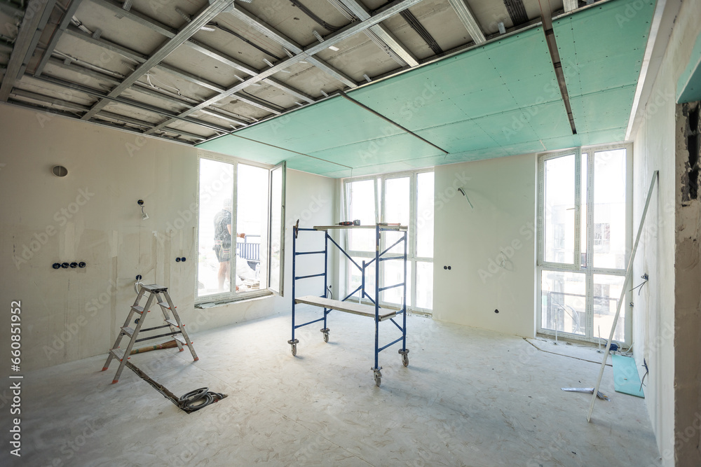 Drywall installation work in progress by construction workers at ...