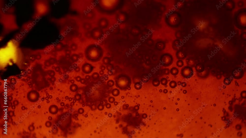 Chemical reaction NaHCO3 and FeCl3 under microscope. Tiny bubbles of ...