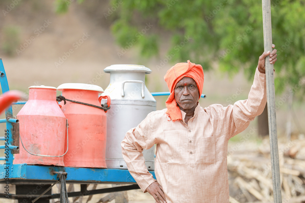 happy Indian farmer selling milk Stock Photo | Adobe Stock