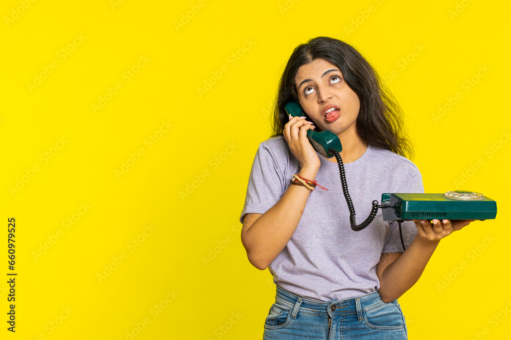 Tired bored Indian woman talking on wired vintage telephone of 80s ...