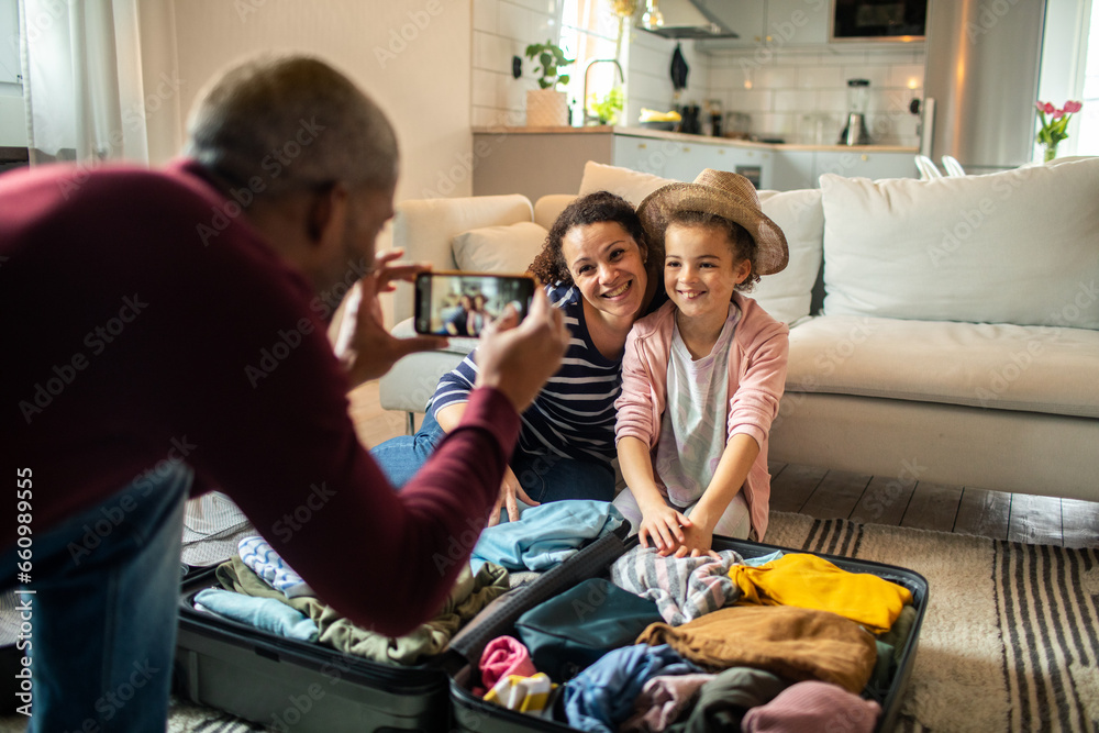 Young mixed mother and her daughter getting their picture taken while ...