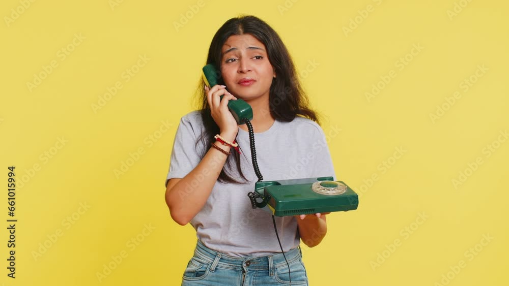 Tired bored Indian woman talking on wired vintage telephone of 80s ...
