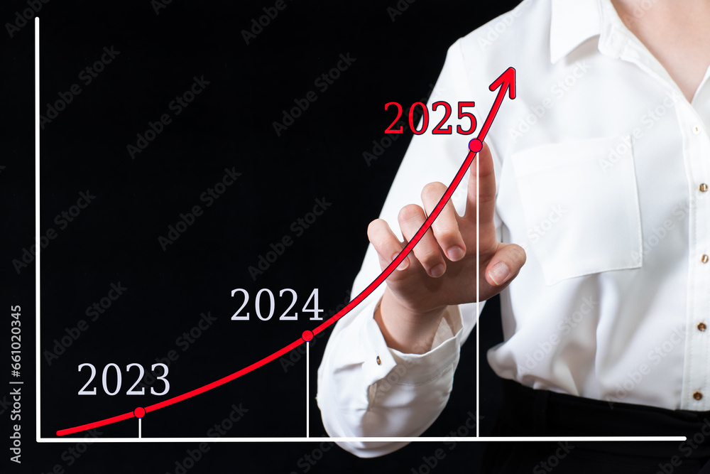 A businessman points his hand on an arrow chart with high growth rates ...