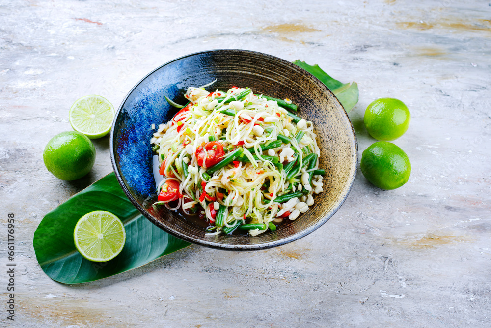 Traditional Thai green papaya som tam salad with green papaya slices ...