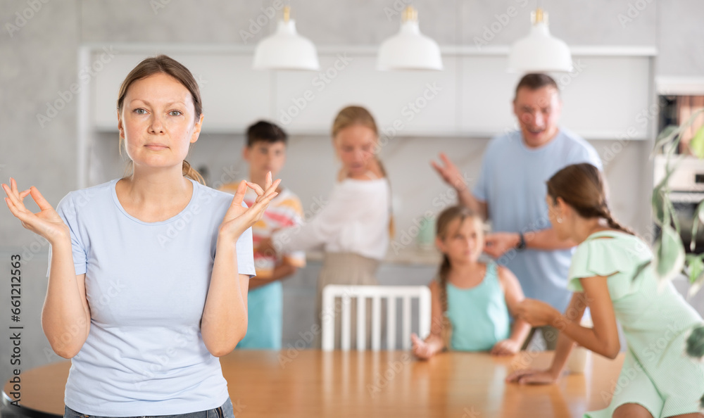 Irritated mom is tired of the noise and screams of the children at home ...