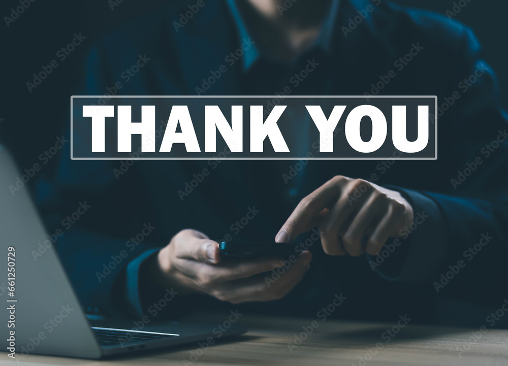 businessman using a phone and sending the message thank you on a ...