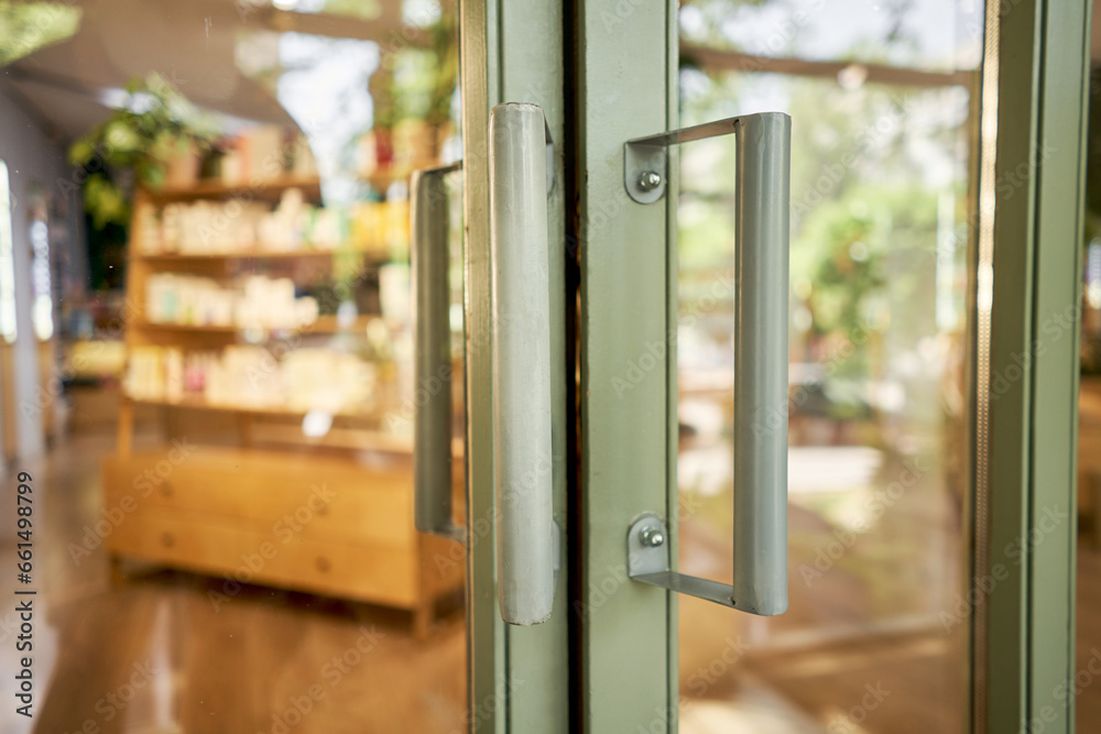 Glass door with handle in to coffee shop or shop. Door handle is a ...