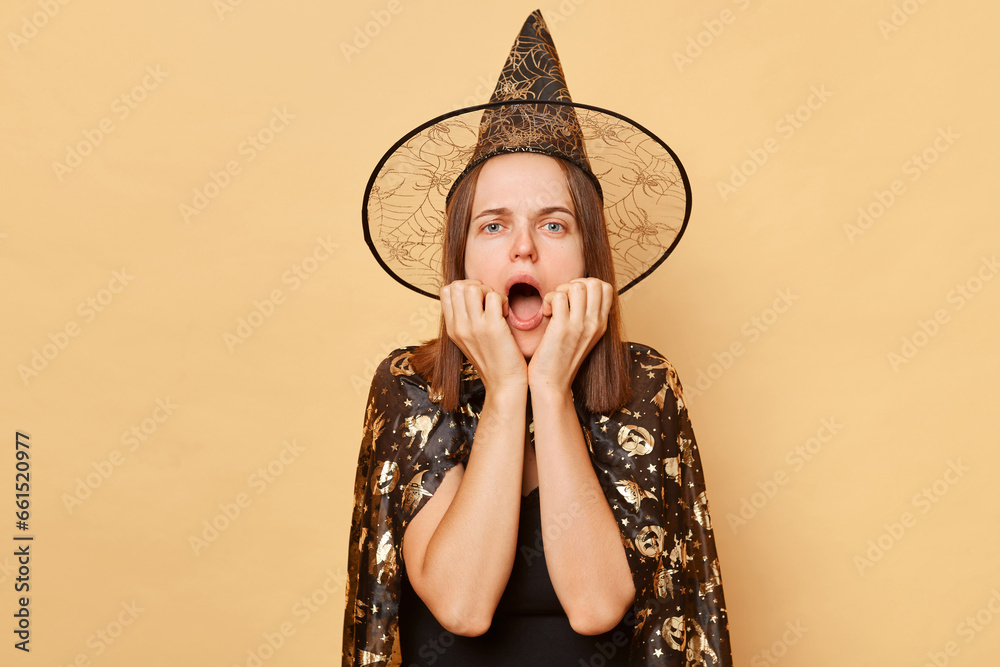 Scared shocked frighten woman wearing witch costume and cone hat ...
