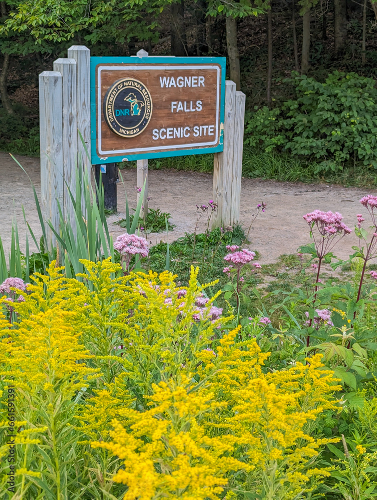 Munising, MI - August 8 2023: Sign for Wagner Falls surrounded by late ...