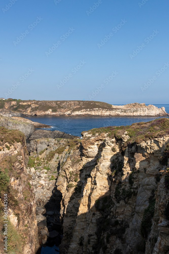 The Rugged Beauty of a Cliffside Coastline Under a Clear Blue Sky Stock ...