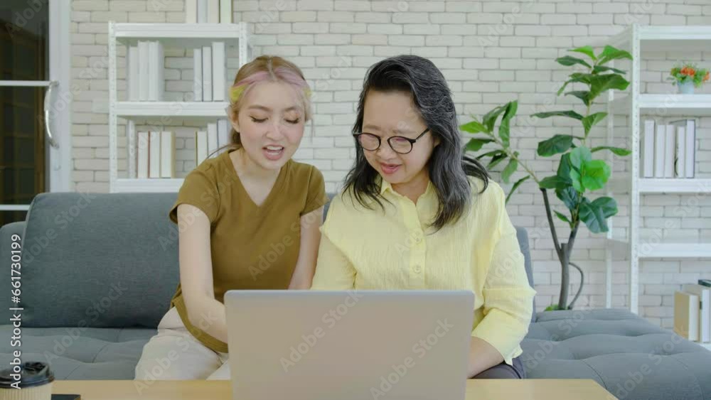 Happy asian mum and beauty daughter having fun talking using learning ...