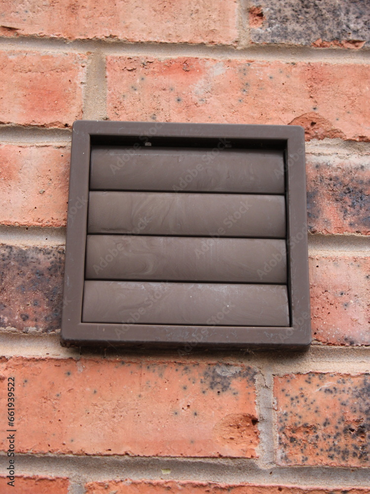 Brown plastic air vent on a residential building commonly used in ...