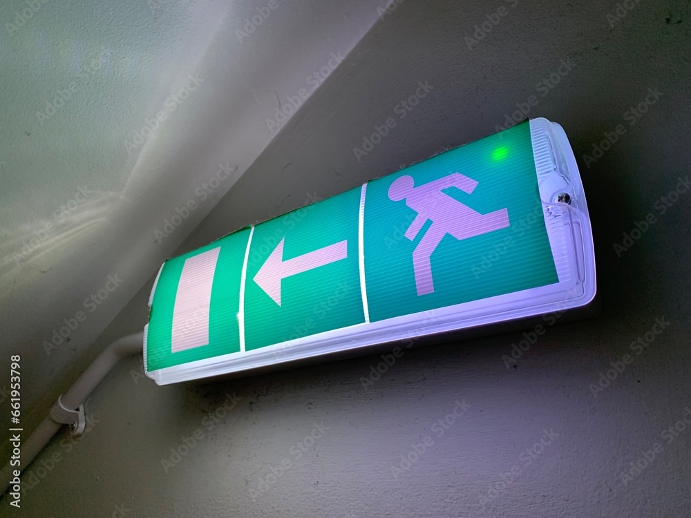 Illuminated emergency exit sign, taken on stairs in a high rise ...