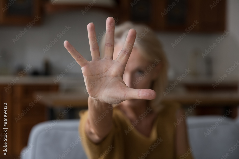 Female palm close up with mature model lady in home background. Scared ...