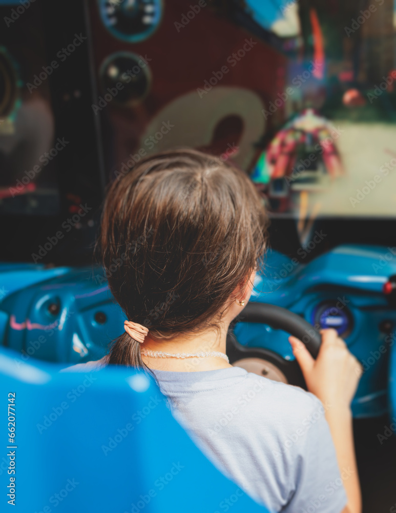 Kids play slot machine at amusement theme park, children play arcade ...